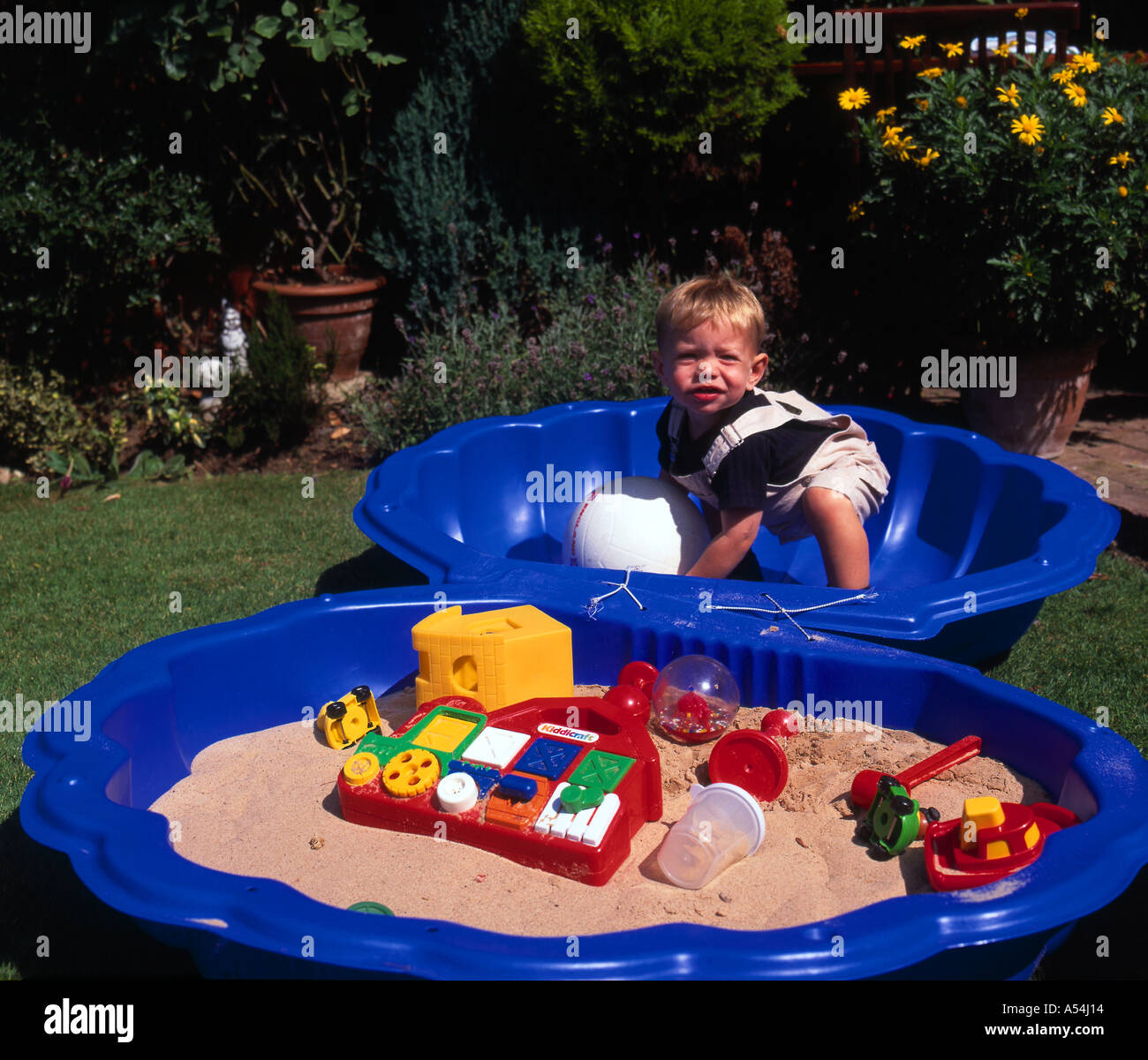 Toddler in sand shell Stock Photo - Alamy