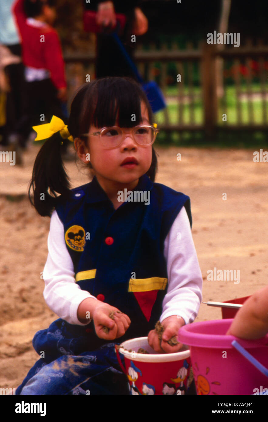 Japanese girl in sand pit Stock Photo - Alamy