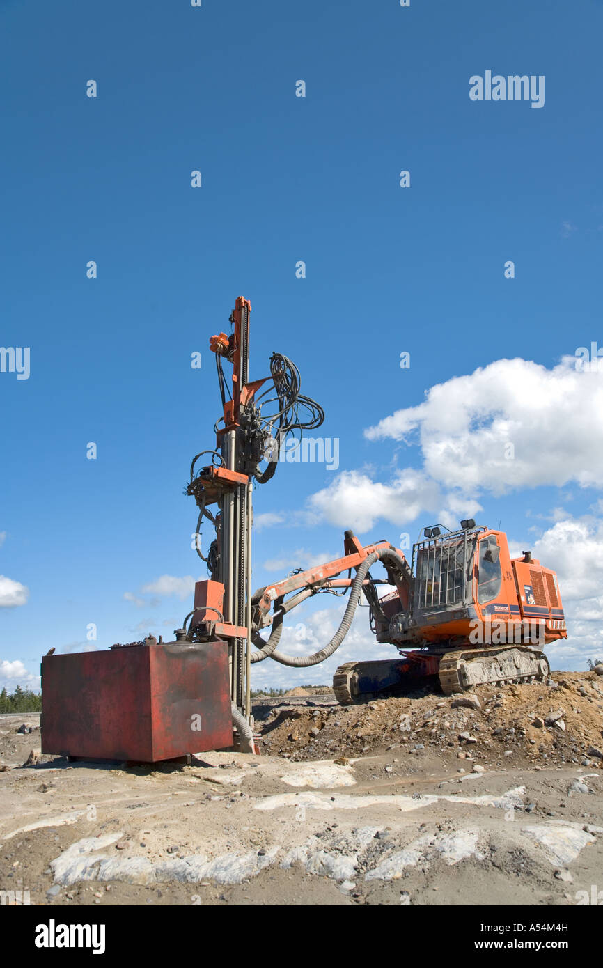 Orange Tamrock Ranger 780 rock drill machine in a rock quarry ready to ...