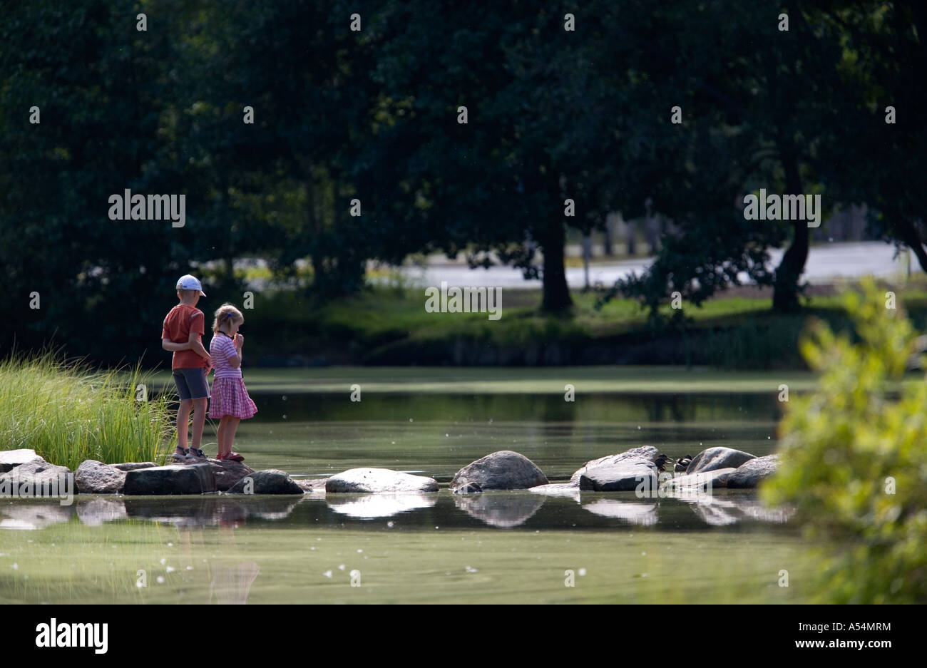 Boy and girl stepping stones hi-res stock photography and images - Alamy