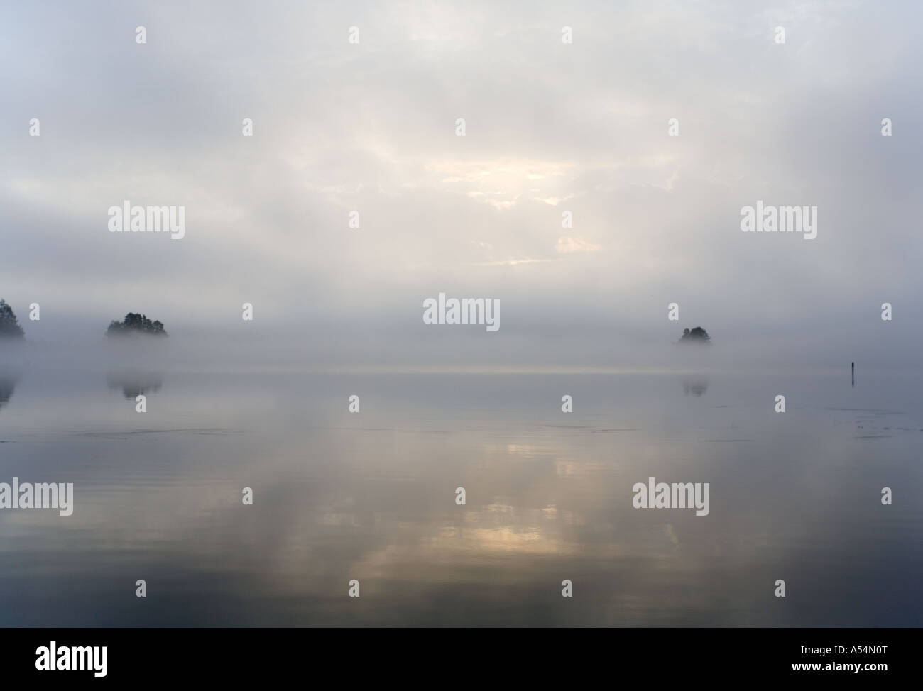 View of flat calm Lake Niinivesi, Finland at the crack of dawn ...