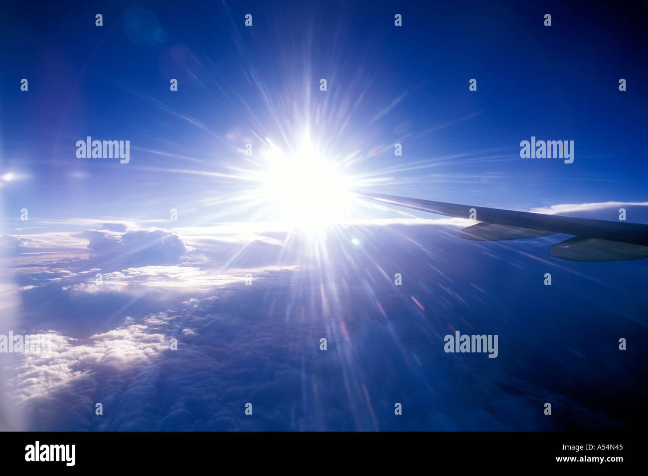 View of airplane wing and sky out of plane window Stock Photo - Alamy