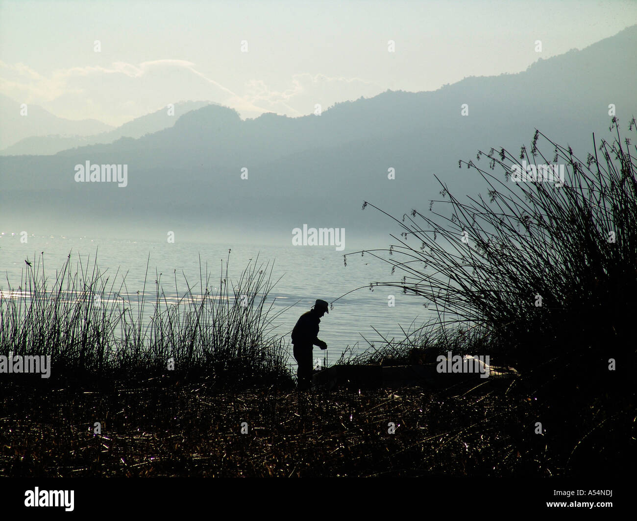 Painet ip1696 guatemala man standing lake atitlan early morning country ...
