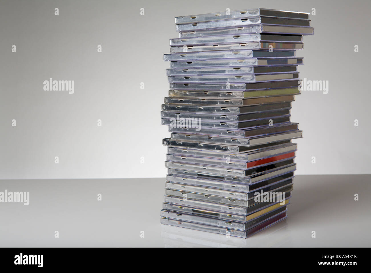 Stack of CD cases standing upright sitting on a white base Stock Photo ...