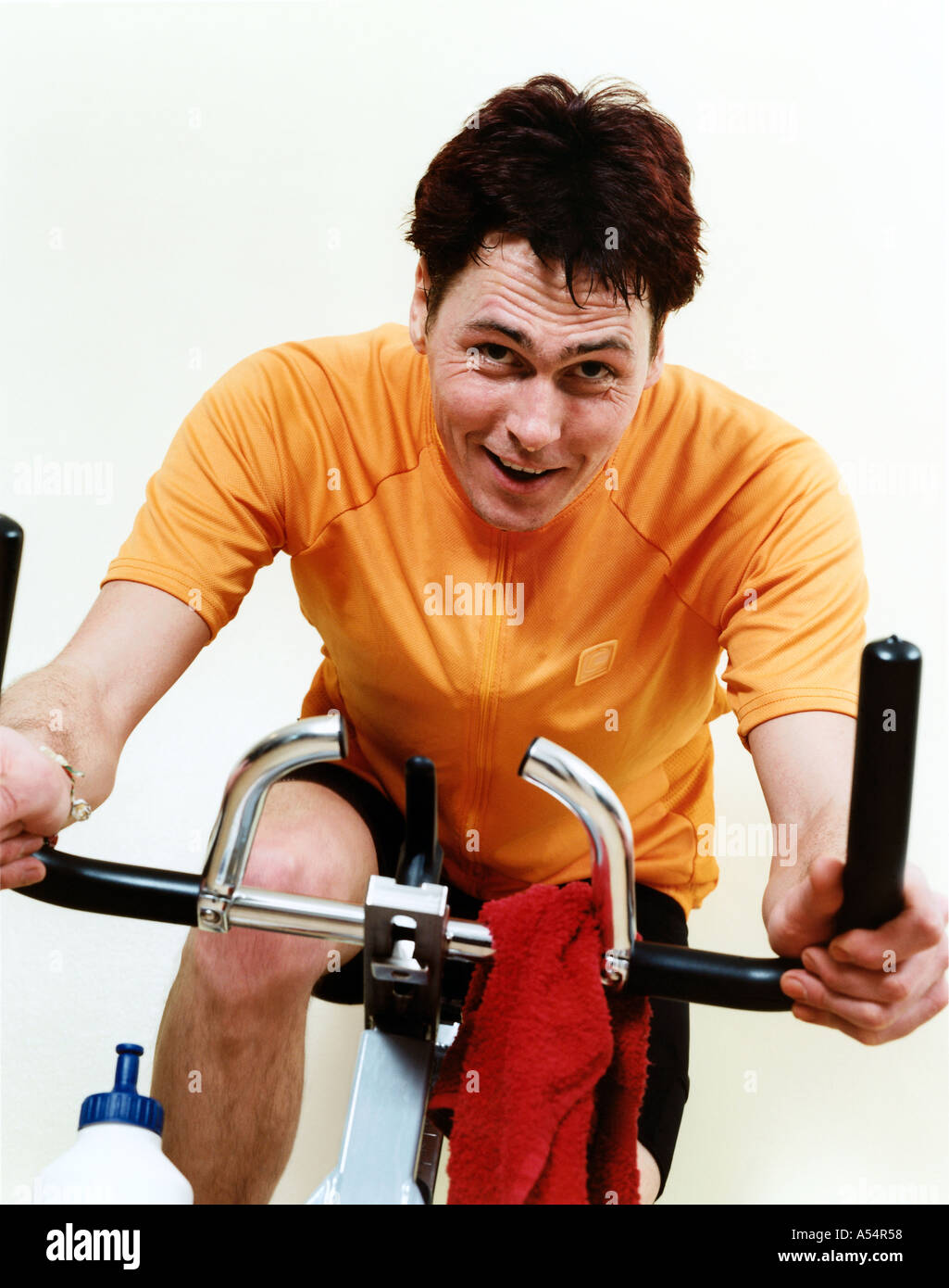 Man in gym training on cycle Stock Photo - Alamy