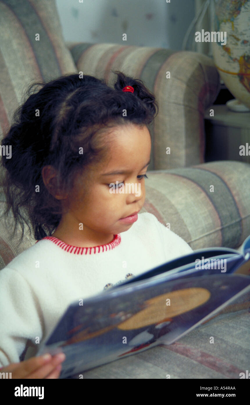 Multi racial girl reading a book St Paul Minnesota Stock Photo - Alamy