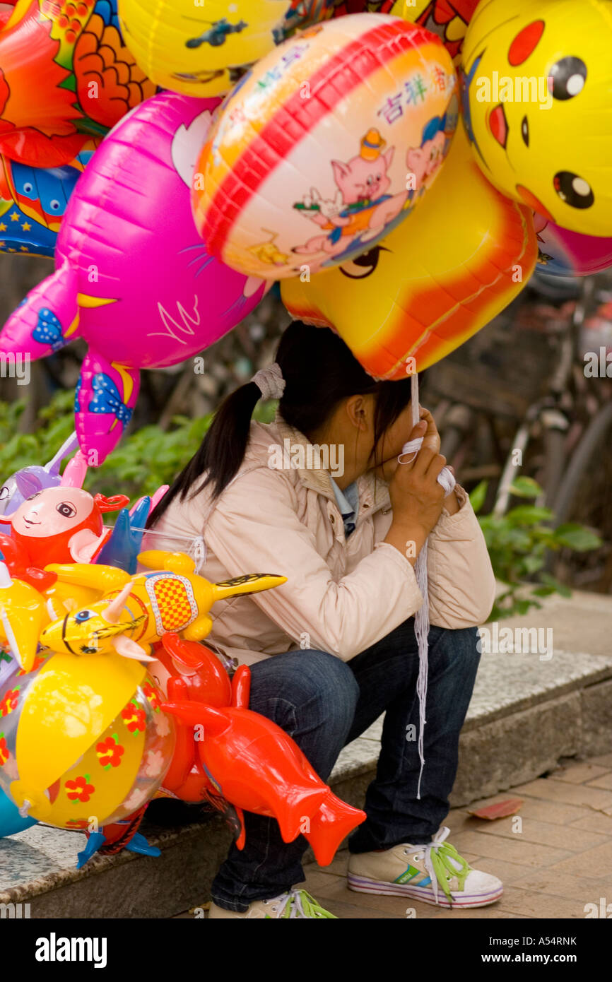 Young girl selling balloons in the park Nanning China Stock Photo - Alamy