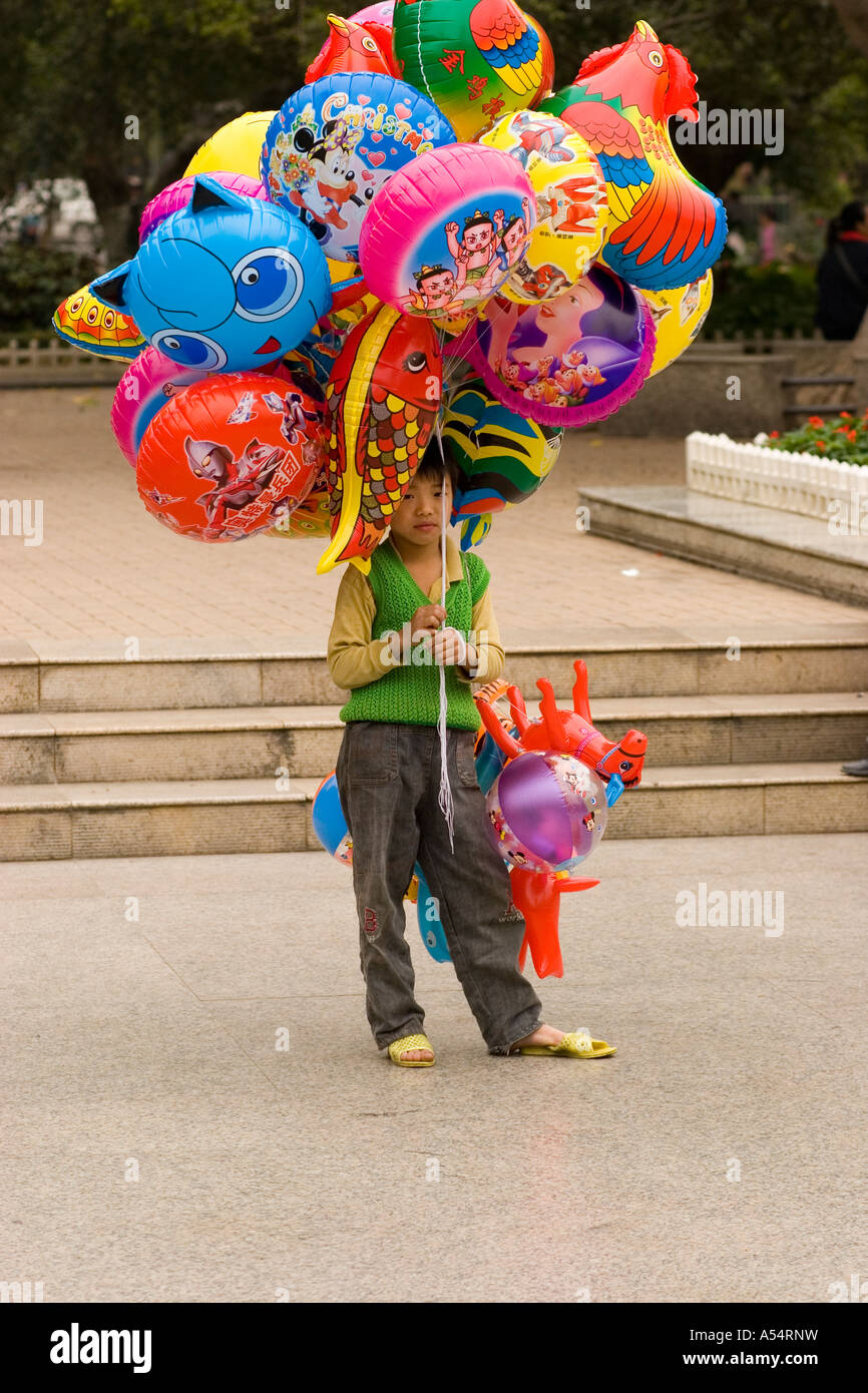 Young boy selling balloons in the park Nanning China Stock Photo - Alamy