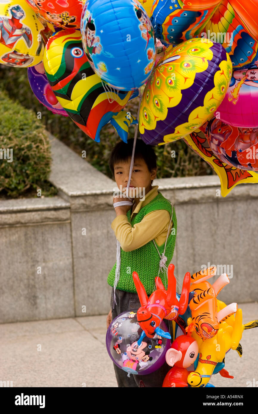 Young boy selling balloons in the park Nanning China Stock Photo - Alamy
