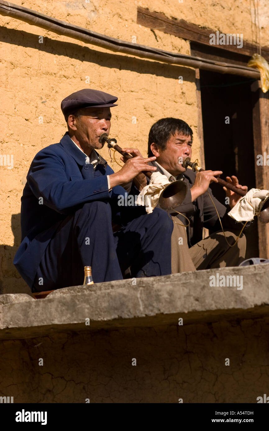 Men playing horns in a village near Yuanyang China Stock Photo - Alamy