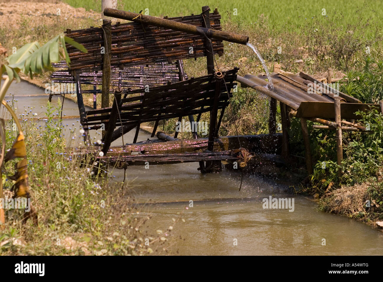 Water wheel irrigation mechanism in rice fields near Menglong China ...