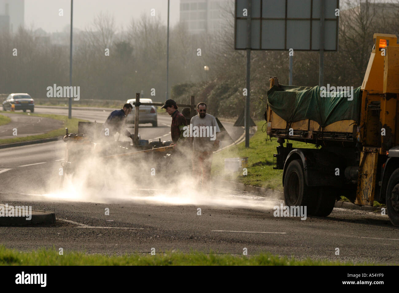 Road construction gang of workers making lots of heat and steam Stock ...