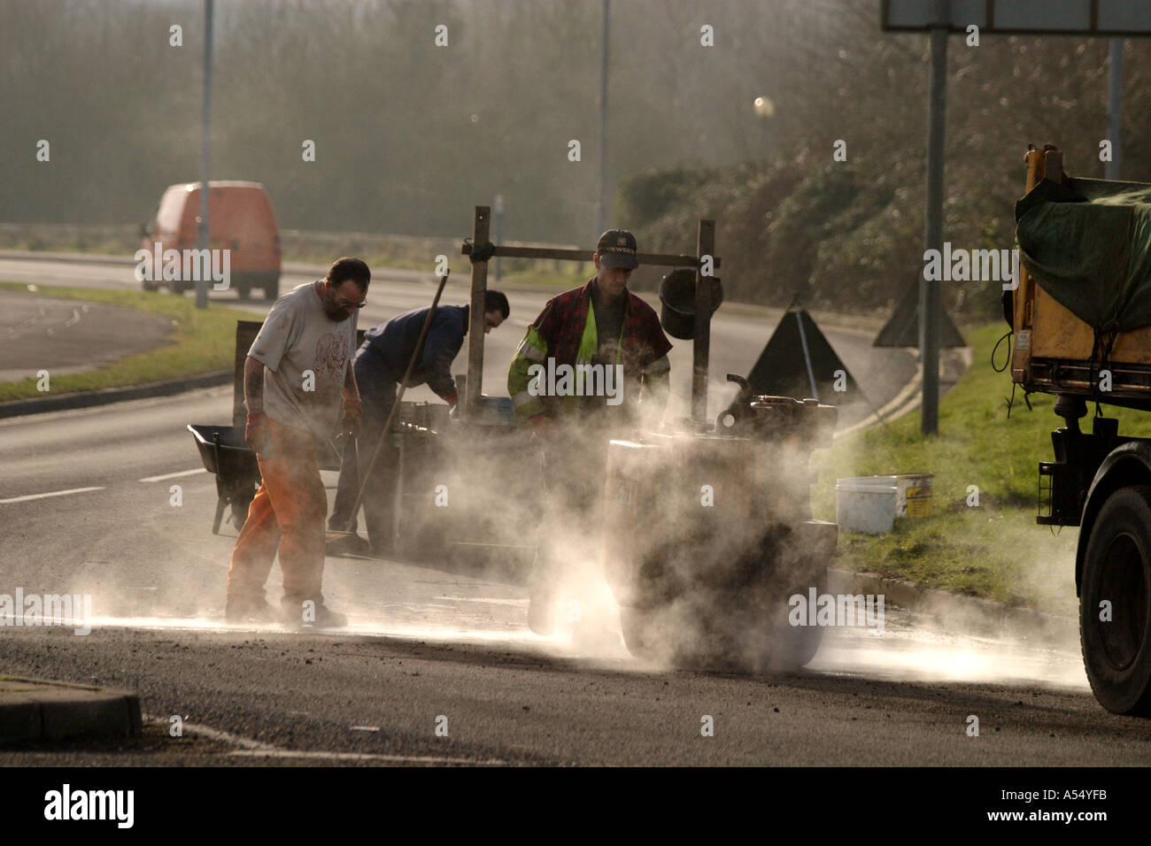 Road construction gang of workers making lots of heat and steam Stock ...