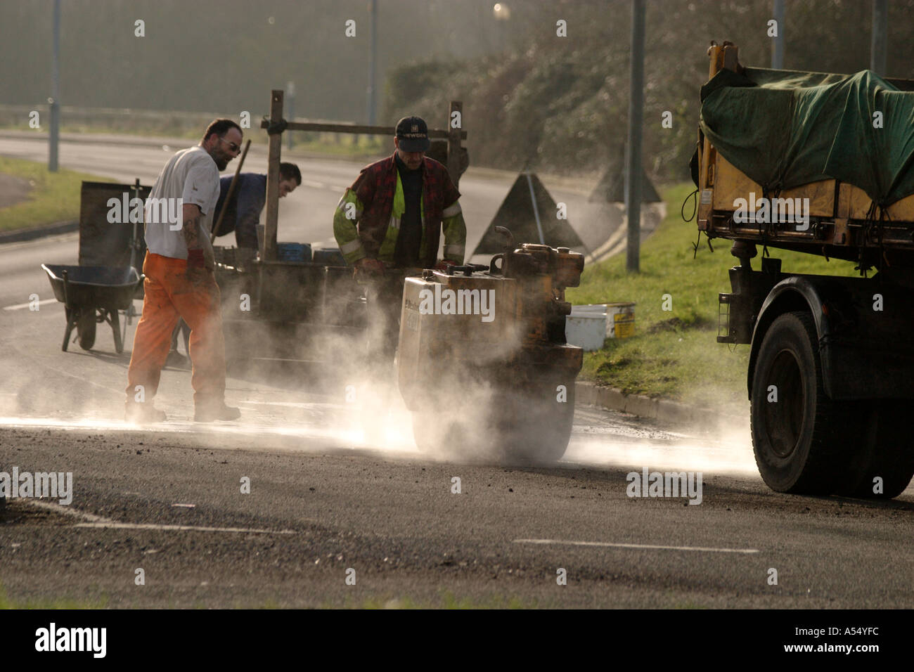 Road construction gang of workers making lots of heat and steam Stock ...