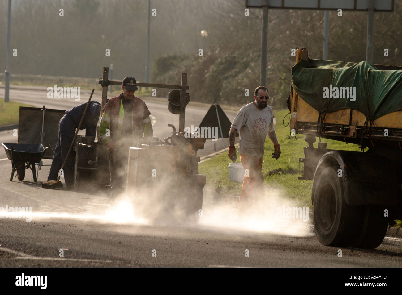 Road construction gang of workers making lots of heat and steam Stock ...
