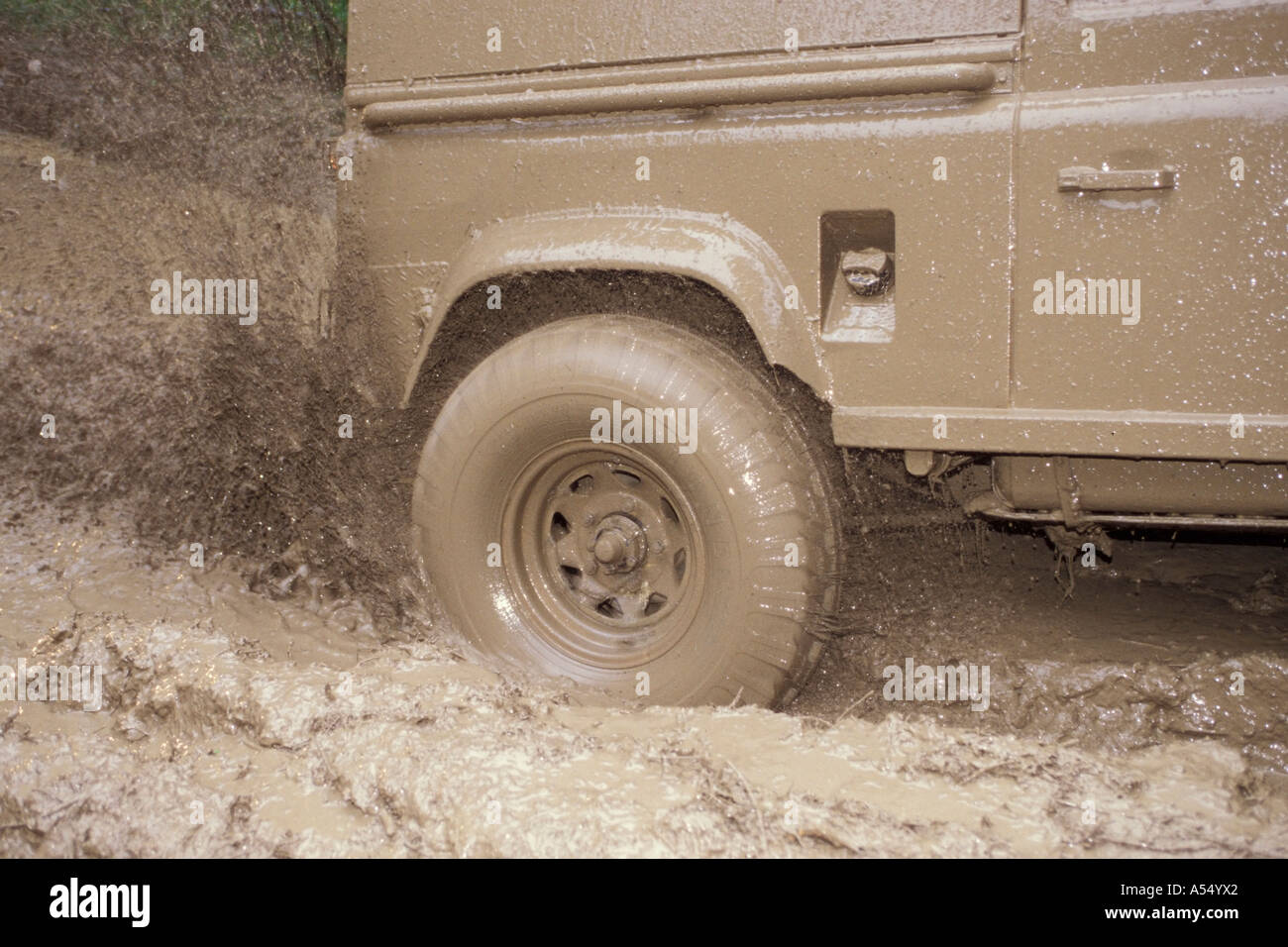 Spinning wheel of offroad vehicle in mud Stock Photo - Alamy