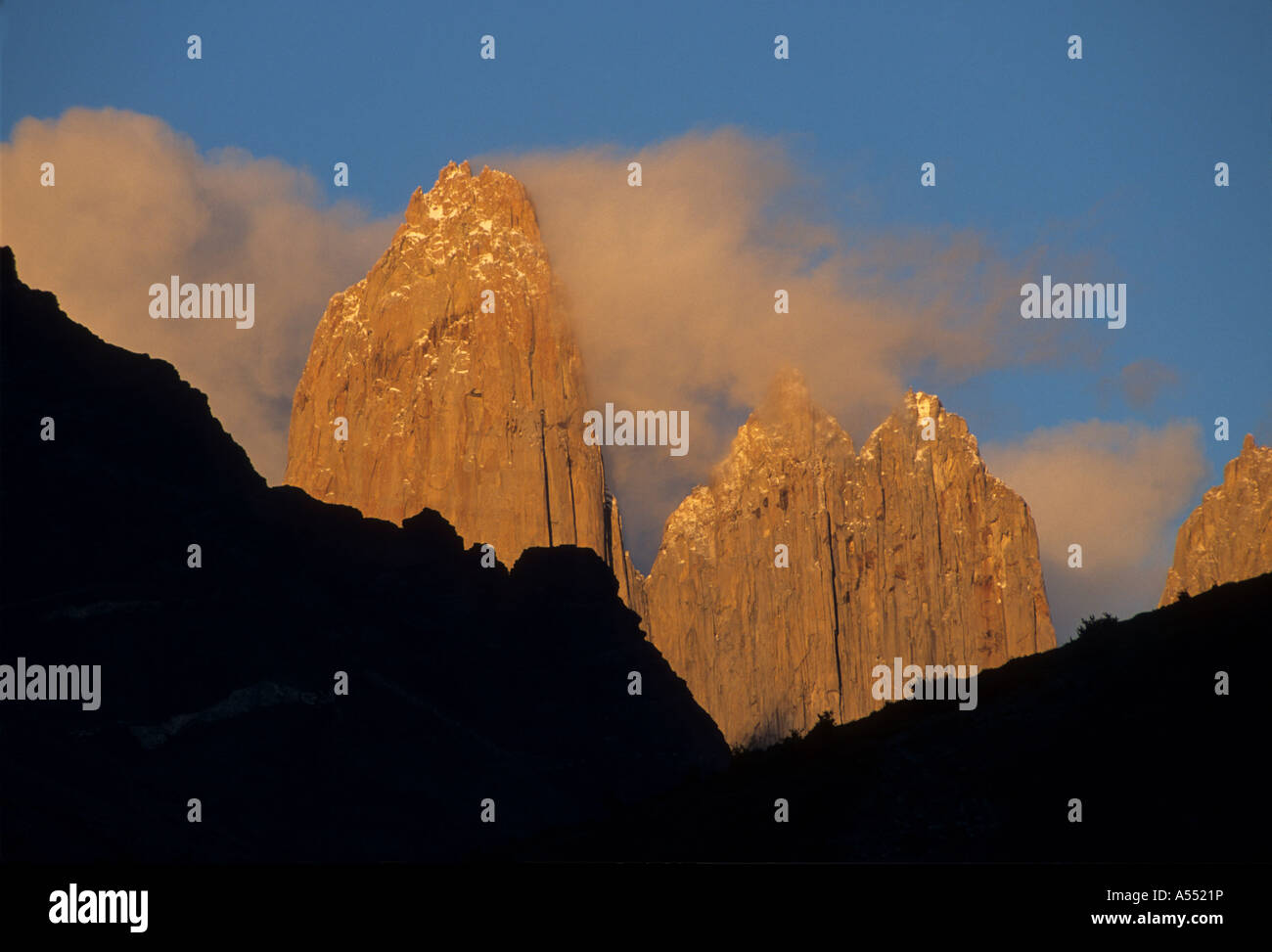 The famous granite towers of Torres del Paine glowing orange at sunrise ...
