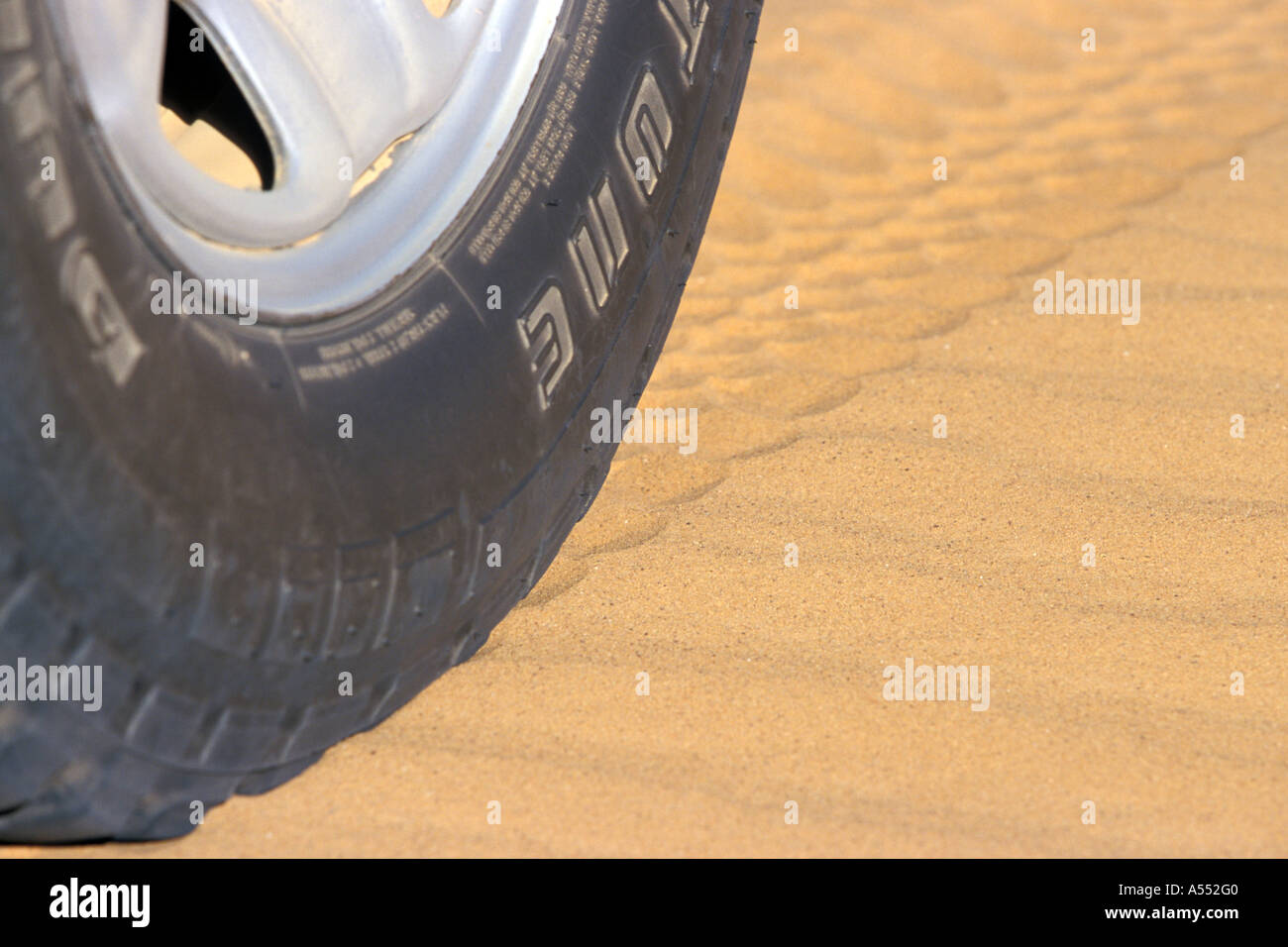 Tyre and track in sand Stock Photo - Alamy