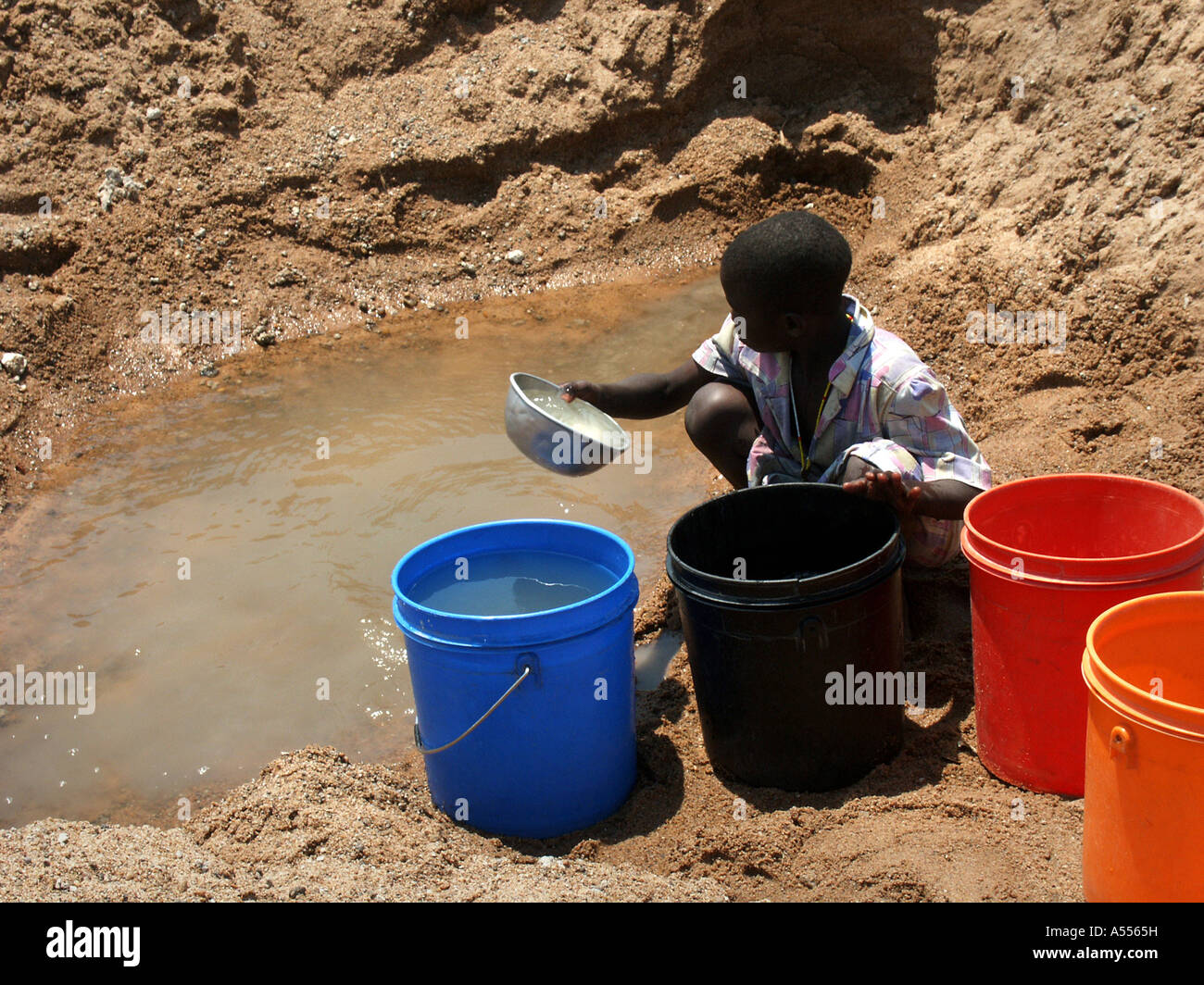 Painet ip2567 tanzania child collecting water dirty well dried up river ...