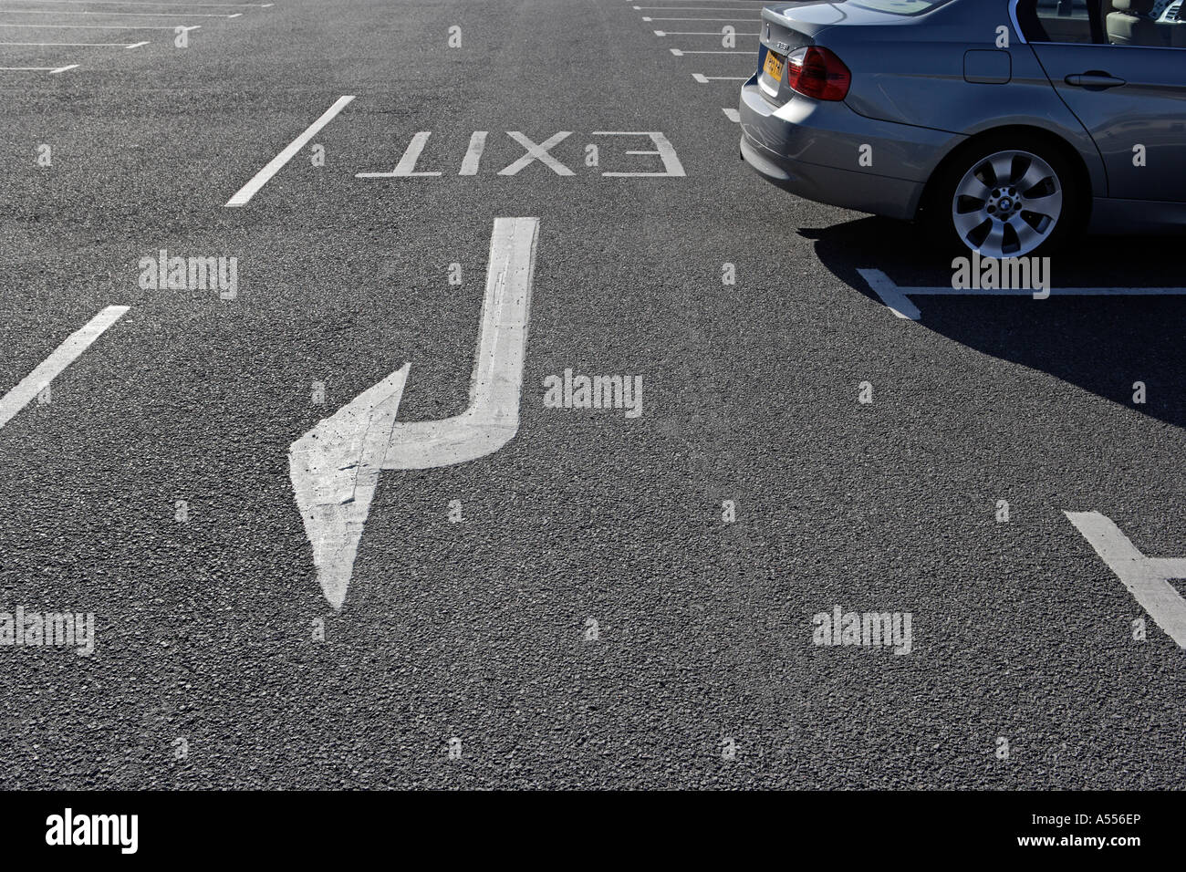 Exit sign and arrow painted on tarmac Stock Photo - Alamy