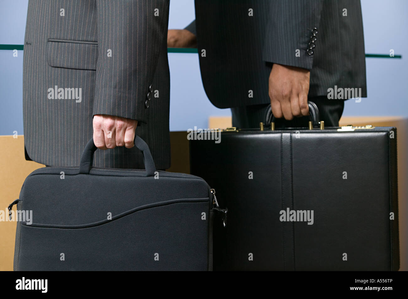 Two businessmen holding briefcases Stock Photo - Alamy