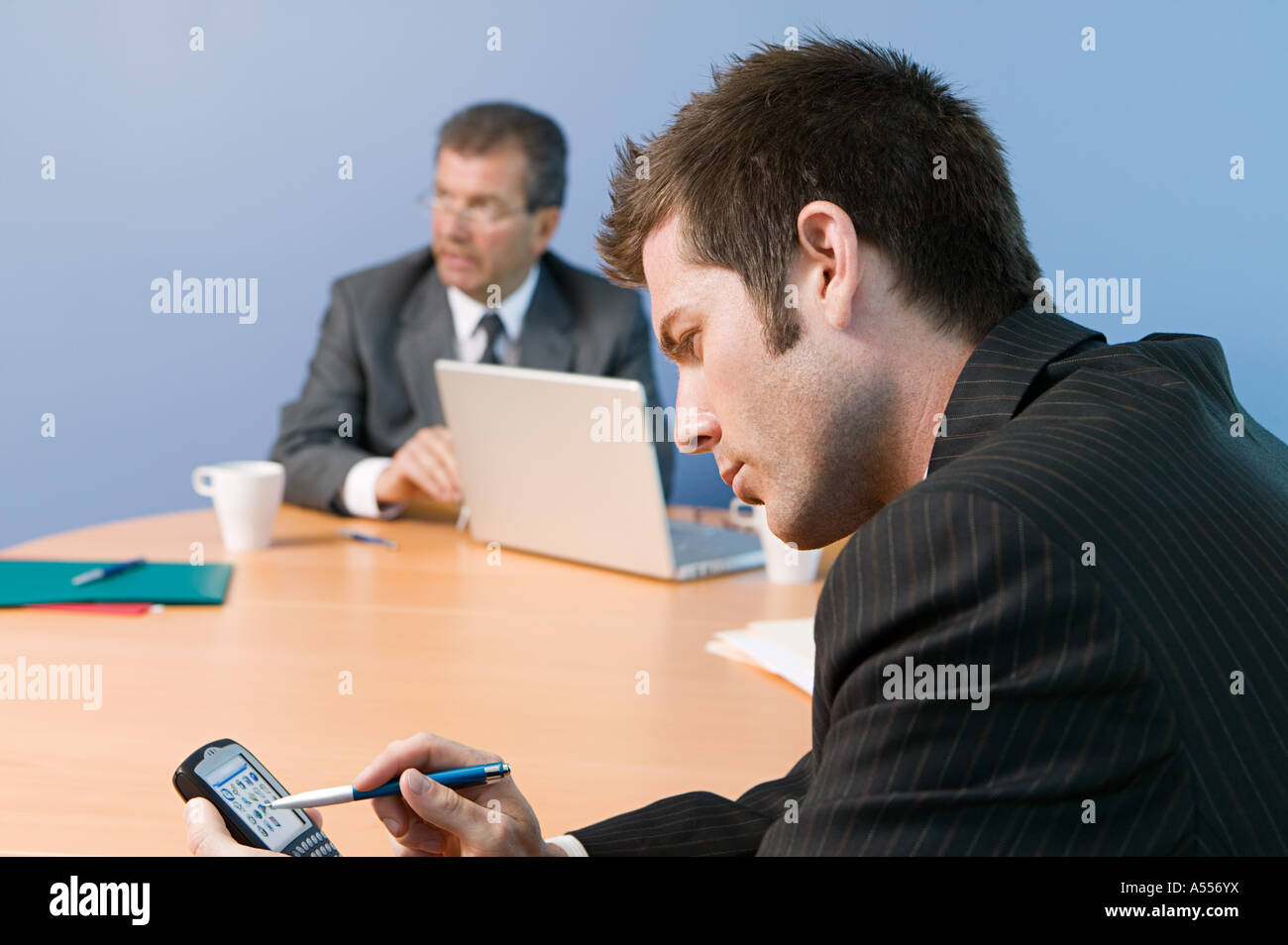 Businessman using hand held computer Stock Photo - Alamy