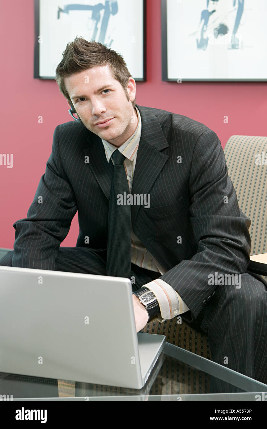 Businessman using laptop and hands free device Stock Photo - Alamy
