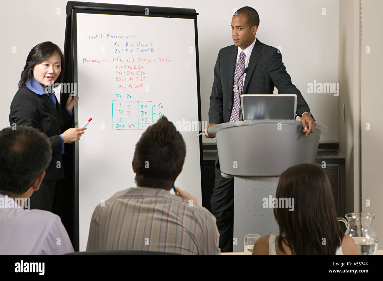 Businesspeople giving presentation Stock Photo - Alamy