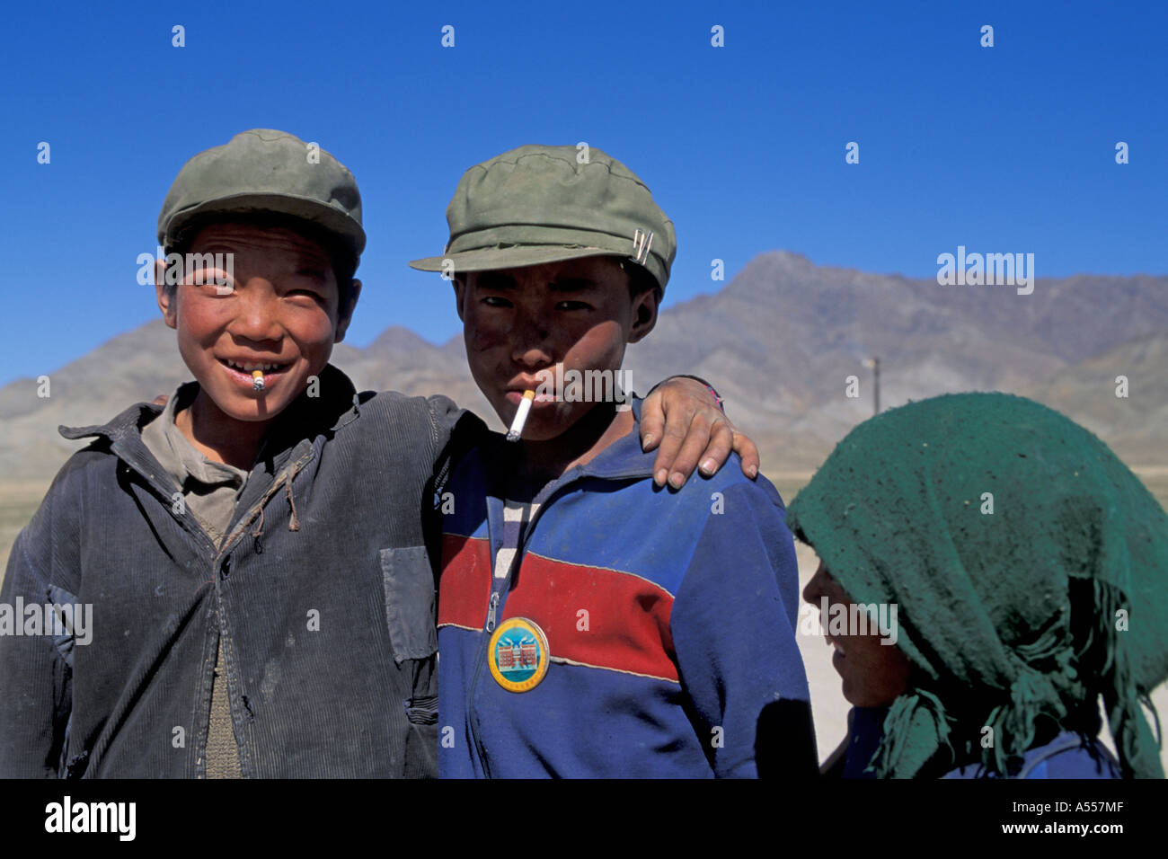 Three smoking chinese children Tibet Stock Photo - Alamy
