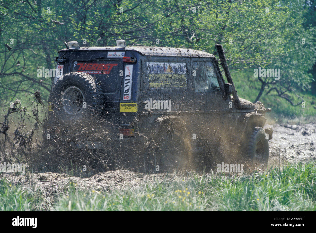 Offroad car is driving through mud and water Stock Photo - Alamy