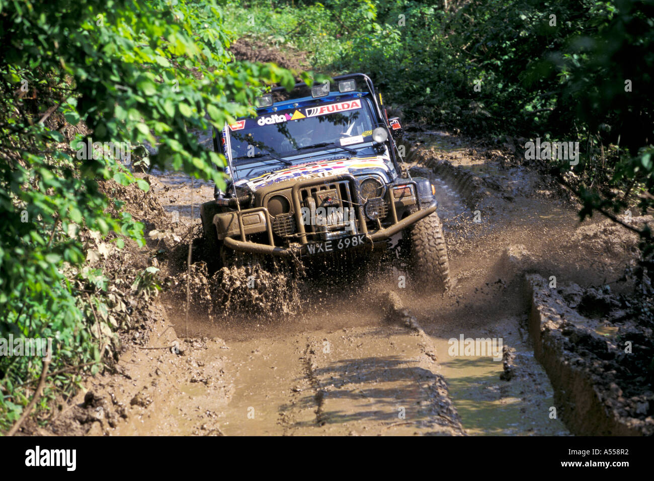 Jeep offroad car on a muddy road Stock Photo - Alamy