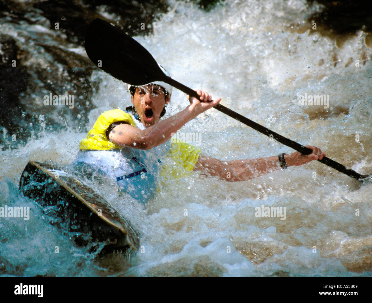Downhill canoeist fighting the wild water Stock Photo - Alamy