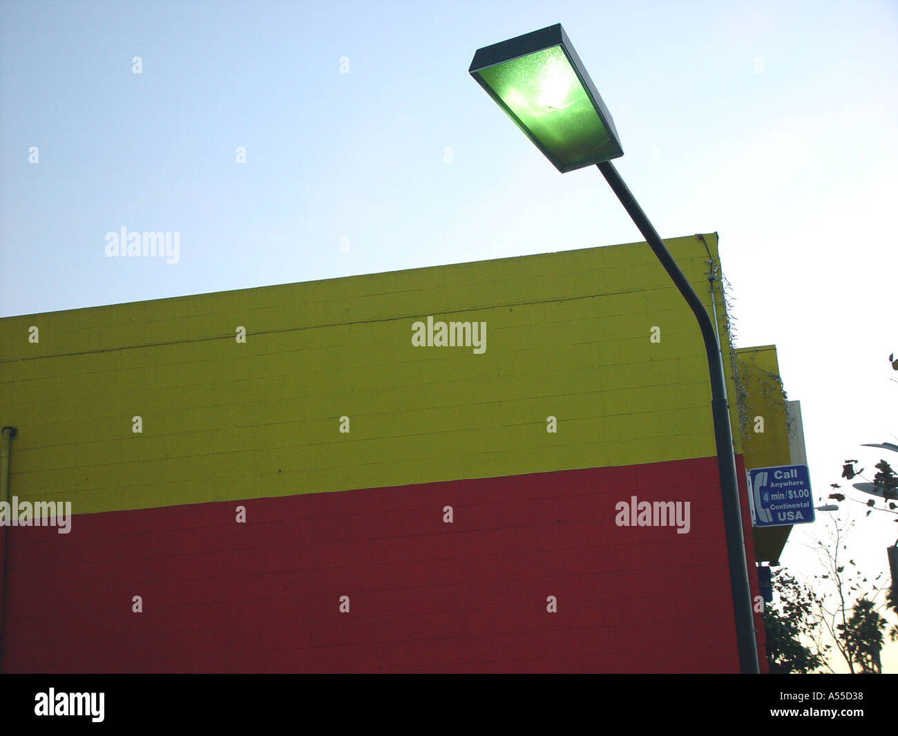 Pink and yellow building wall with streetlight and view of sky Stock ...