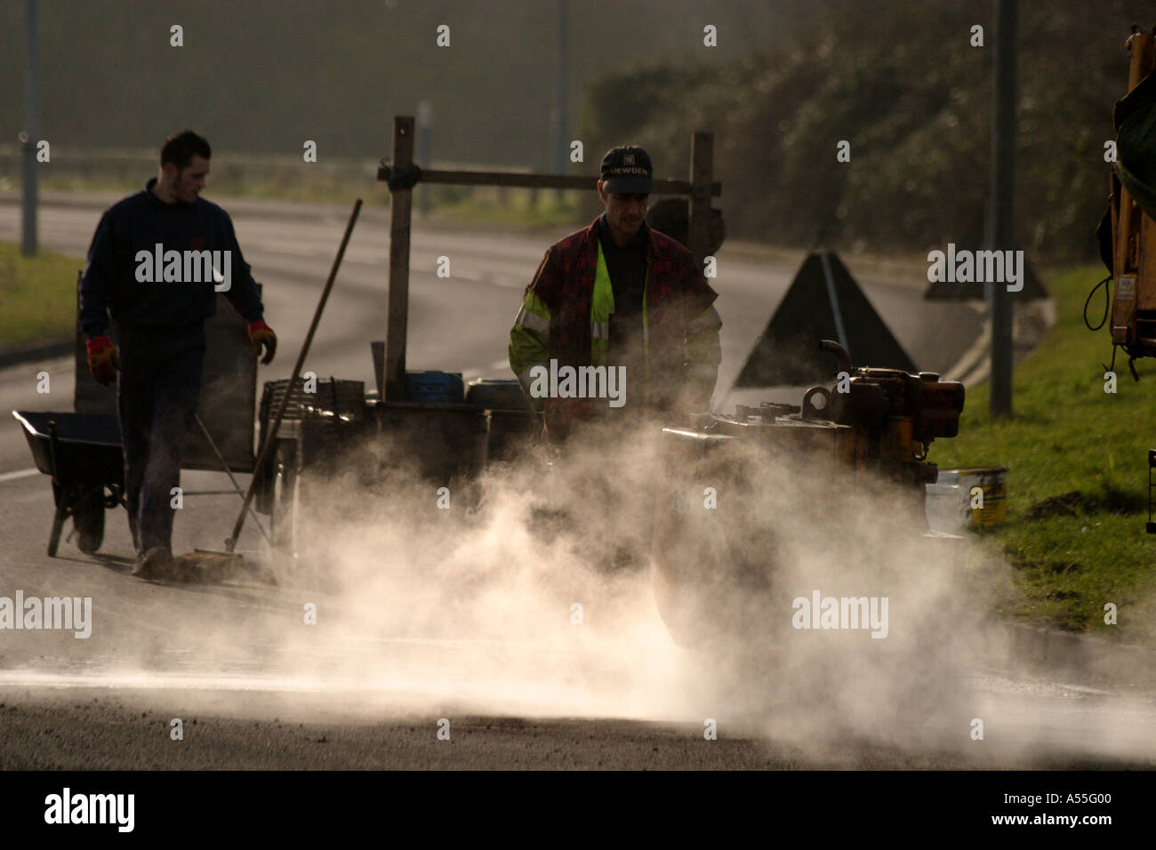 Road construction gang of workers making lots of heat and steam Stock ...