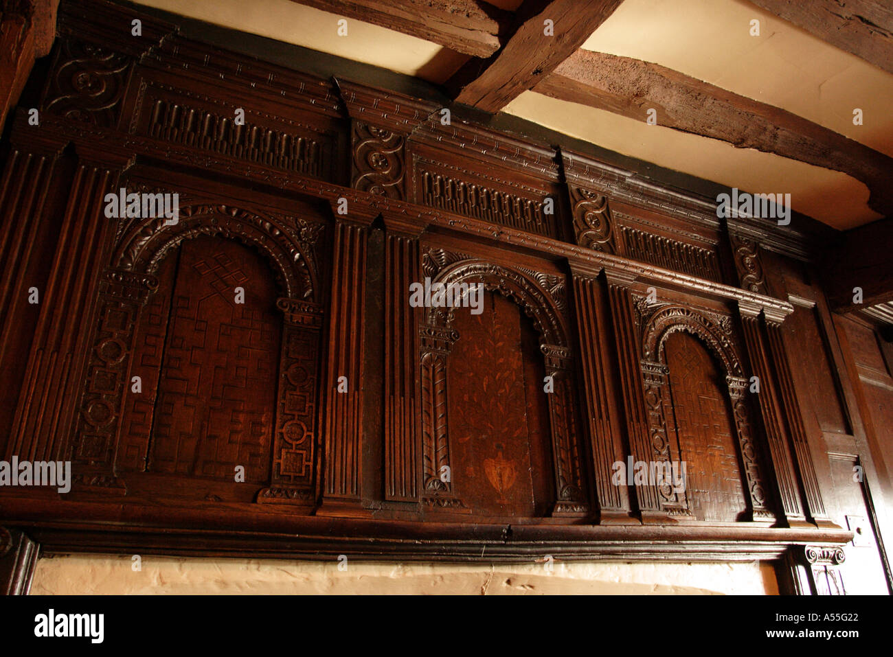 Elizabethan wooden oak panelling and arches over fireplace Stock Photo ...