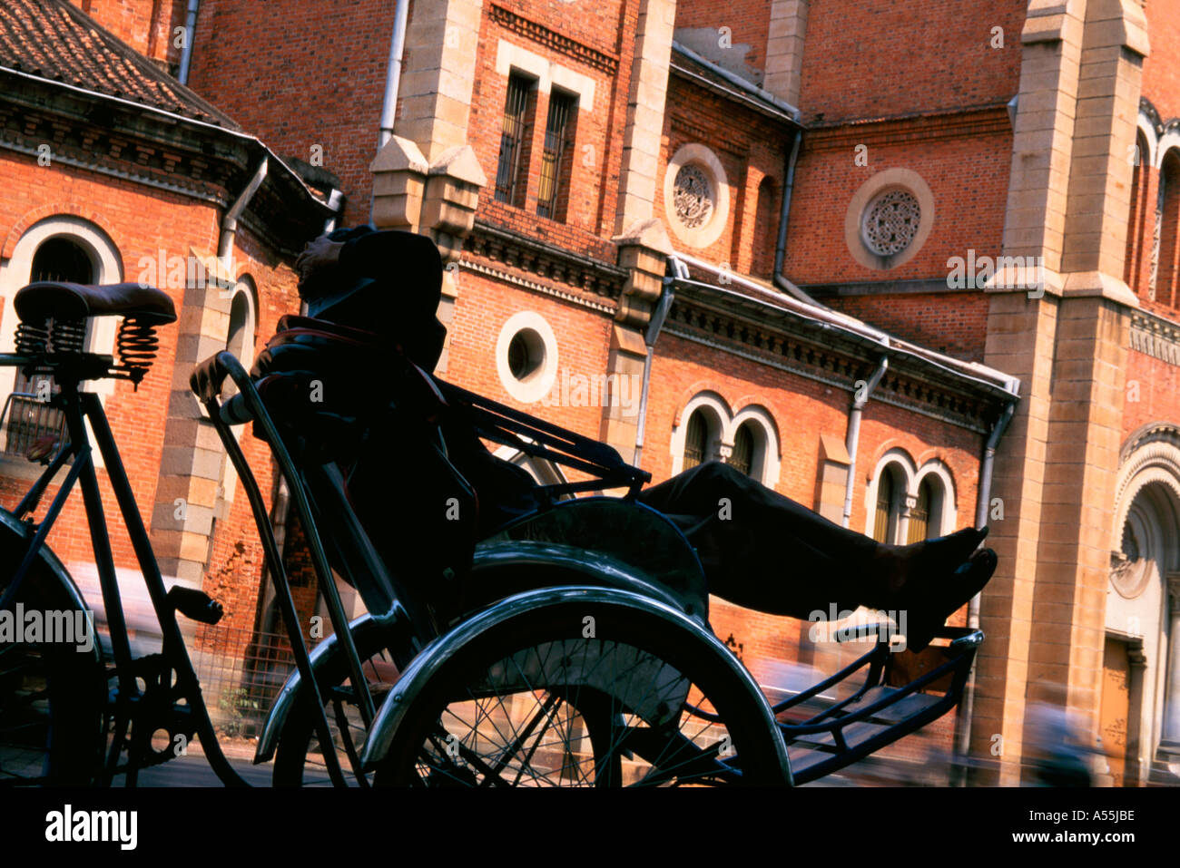 Cyclo driver with Notre Dame Cathedral Saigon Vietnam Stock Photo - Alamy