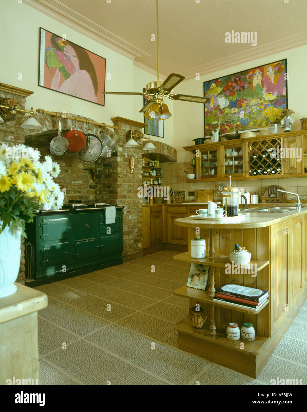 Green Aga oven in traditional kitchen with peninsular unit and ceiling ...