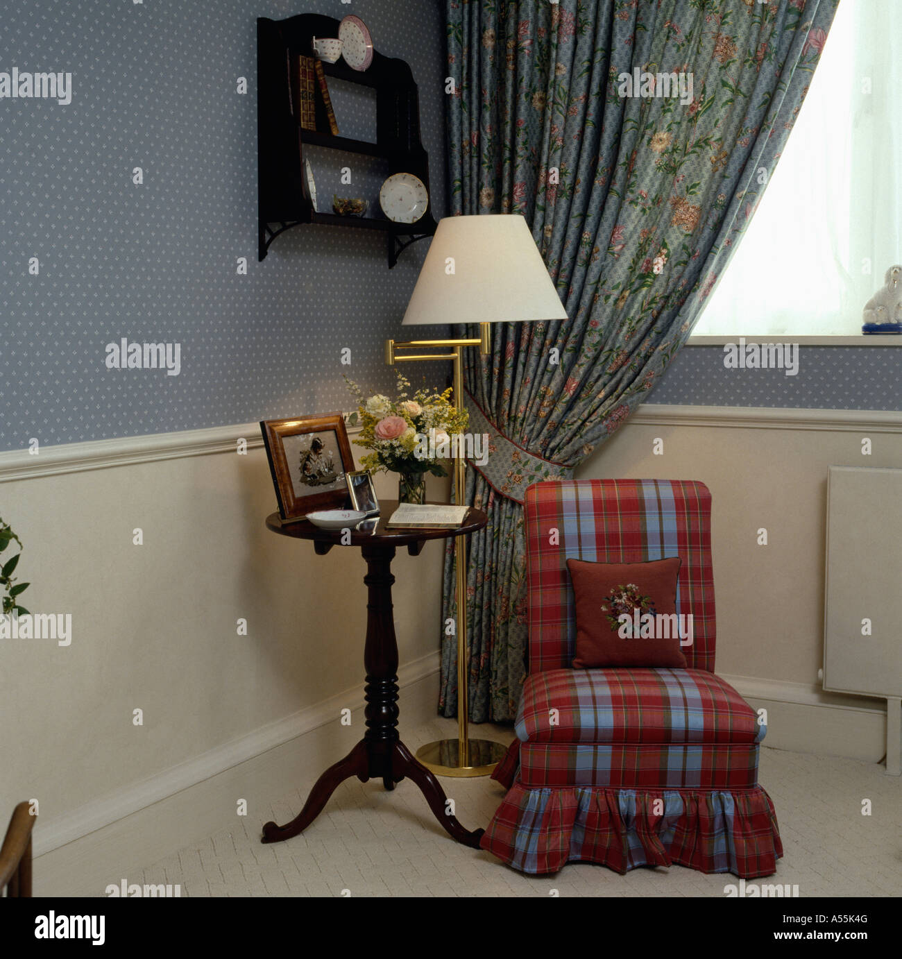 Blue and red check patterned upholstered chair in corner of blue ...