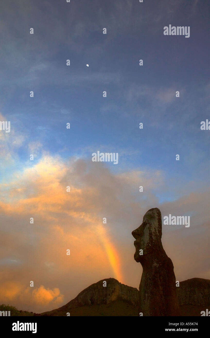 A lone Moai volcanic stone sculpture with rainbow at Ahu Tongariki ...