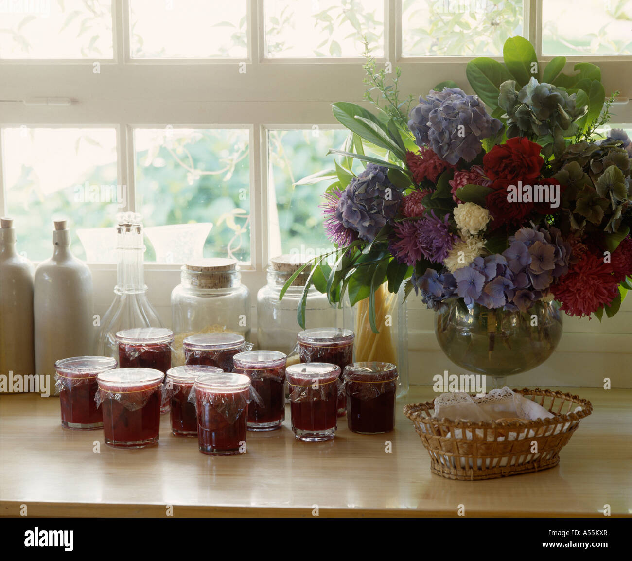 Close-up of jars of jam and fresh flowers on windowill Stock Photo - Alamy
