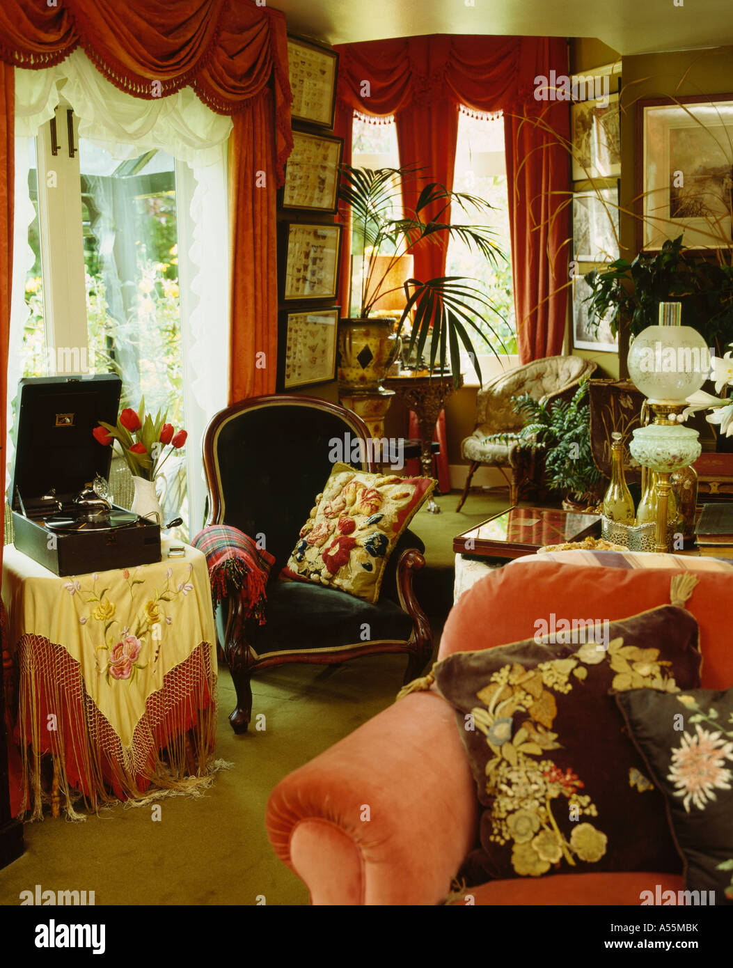 Edwardian sittingroom with tapestry cushions on settee and armchair and ...