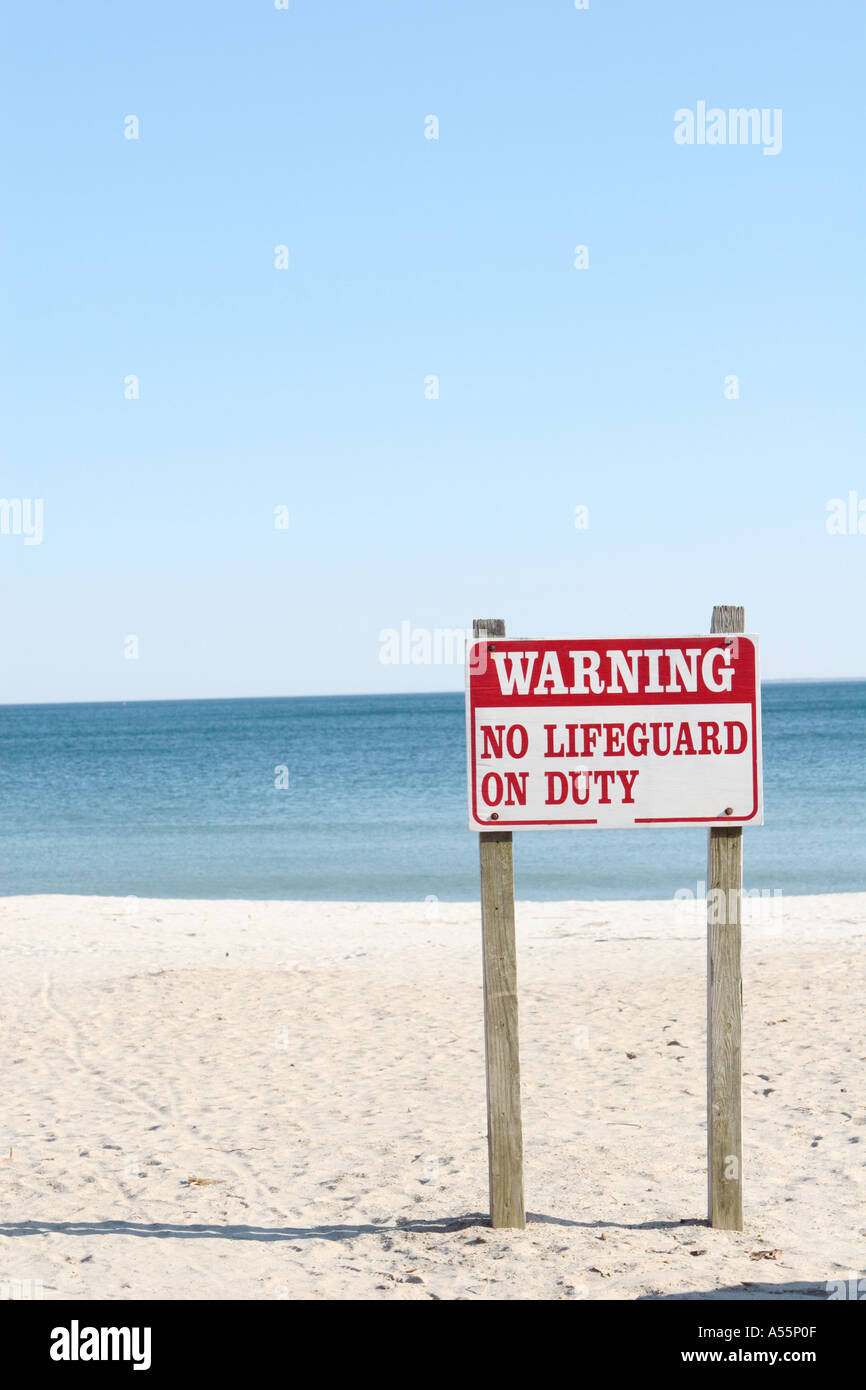 Sign posted on empty beach Stock Photo - Alamy