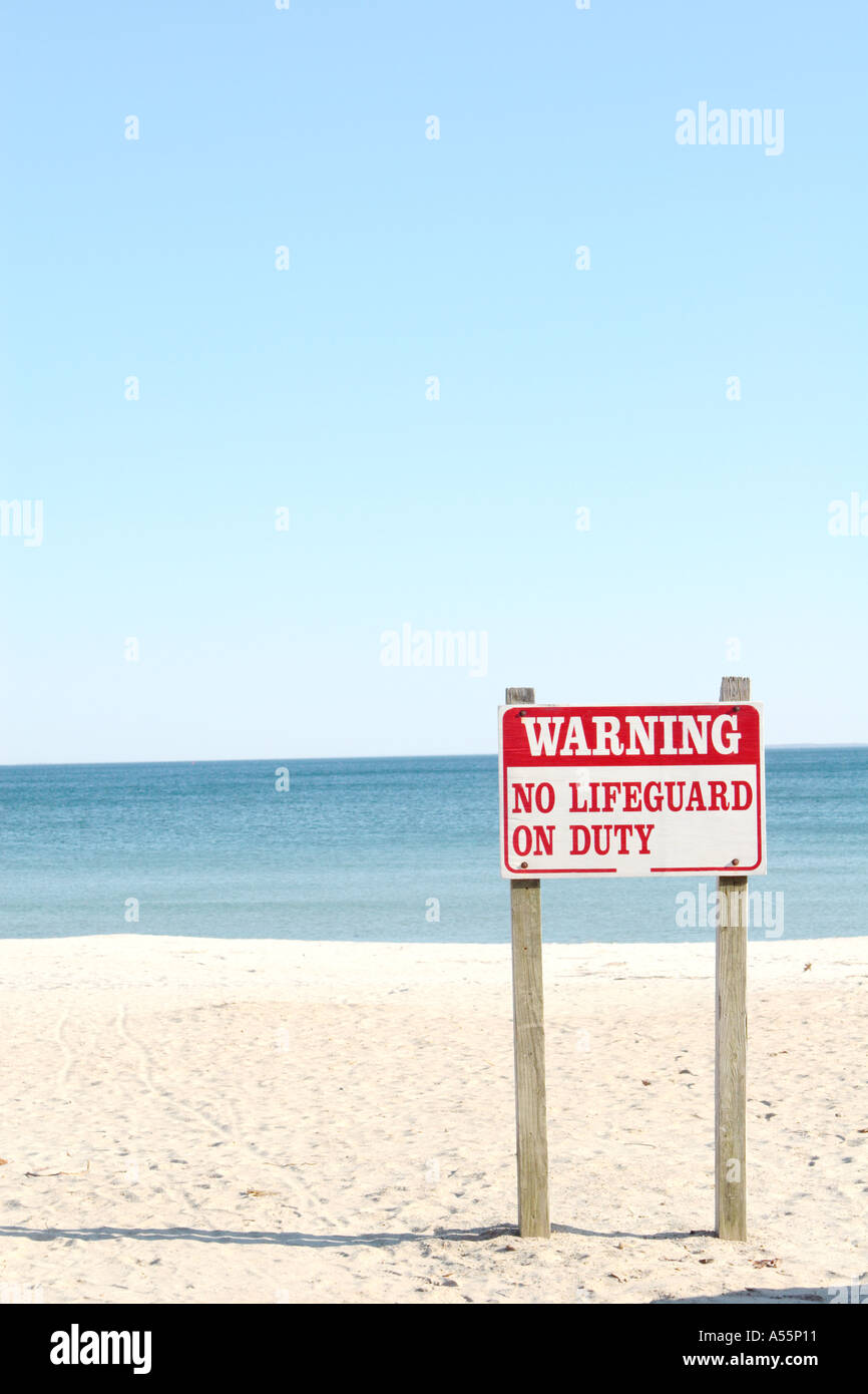 Sign posted on empty beach Stock Photo - Alamy