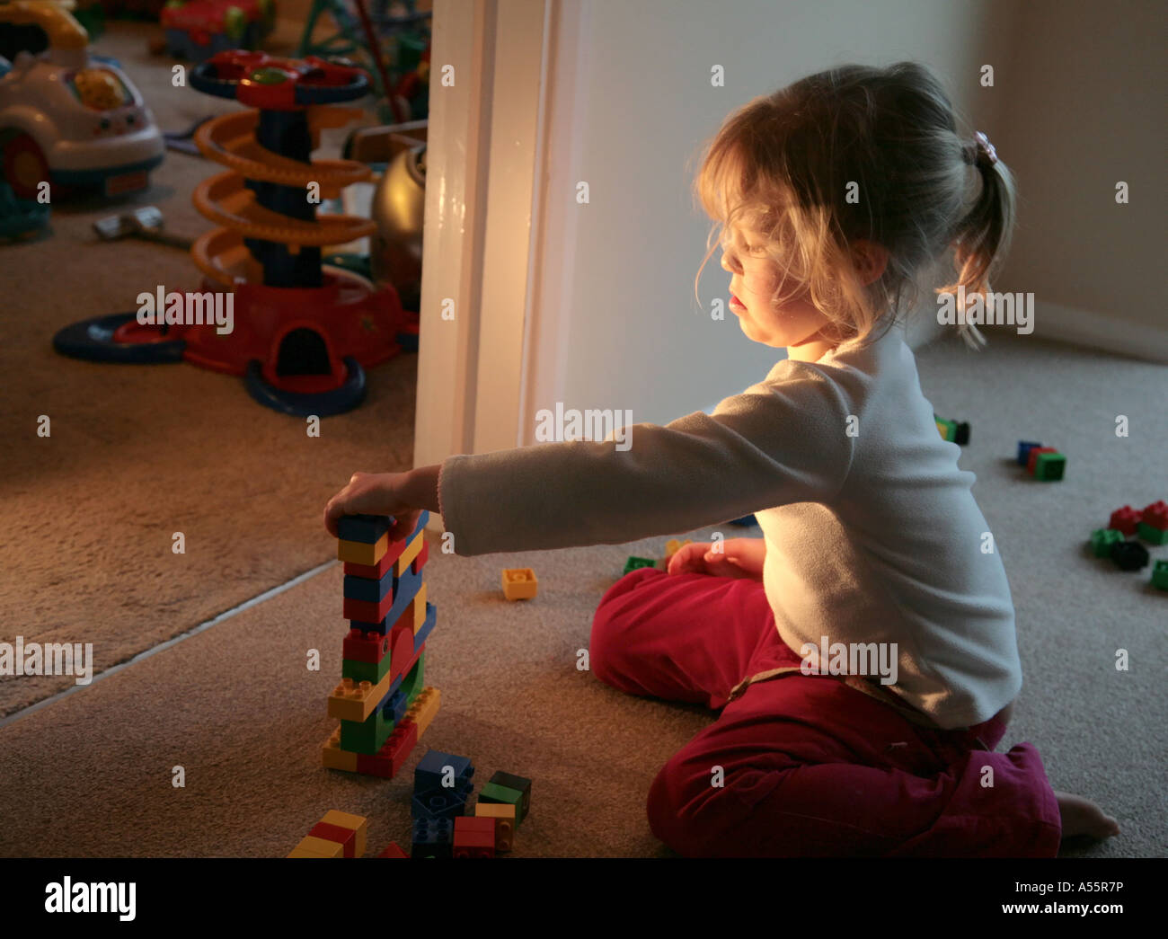 young girl playing with lego in home Stock Photo - Alamy