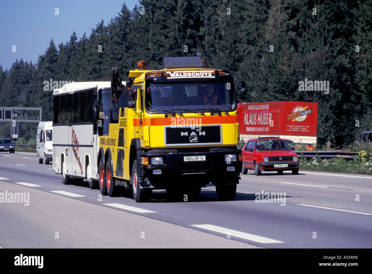 Tow-car breakdown lorry is towing bus Stock Photo - Alamy