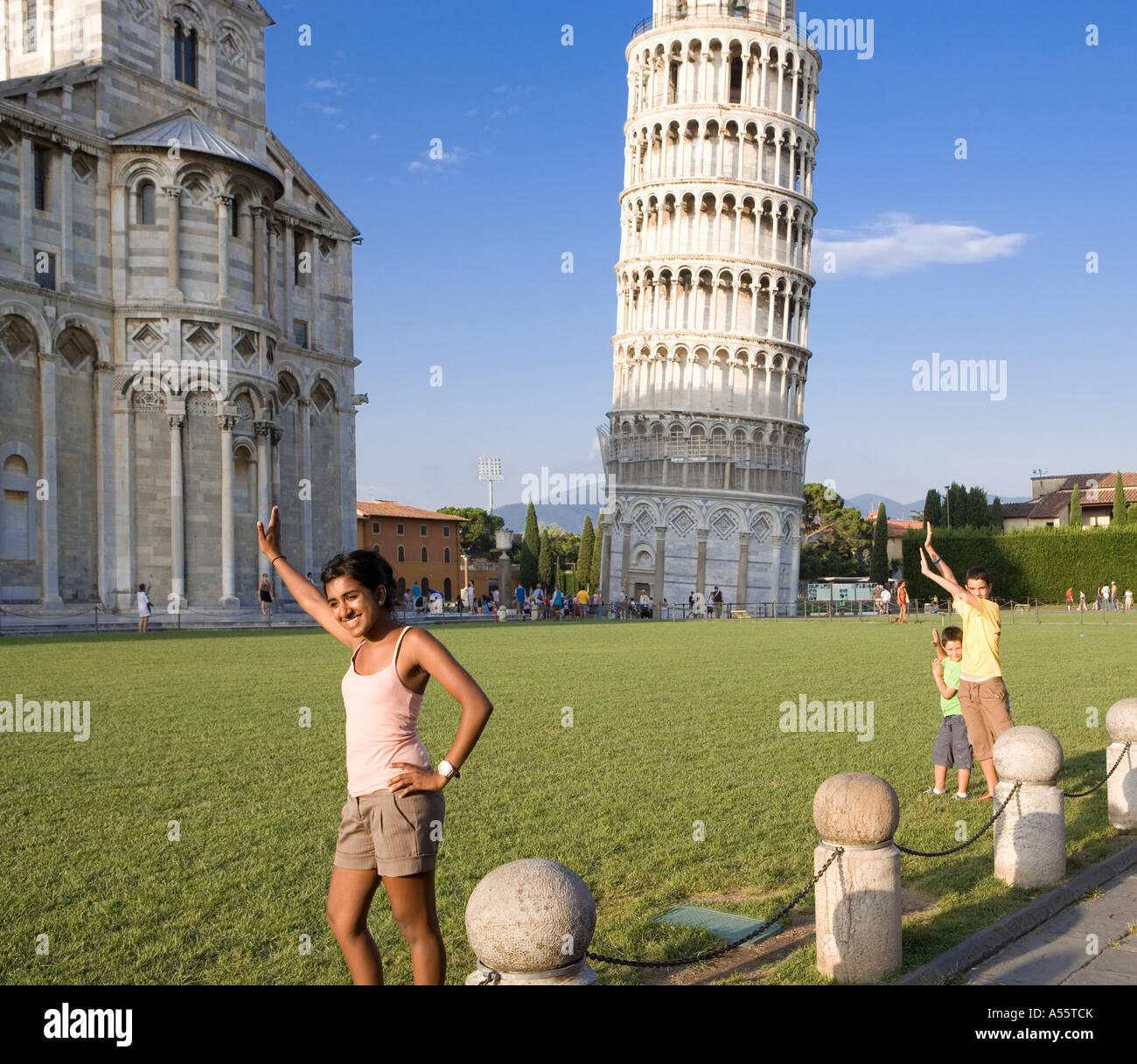 Tourists holding up the Leaning Tower of Pisa Tuscany Italy Stock Photo ...