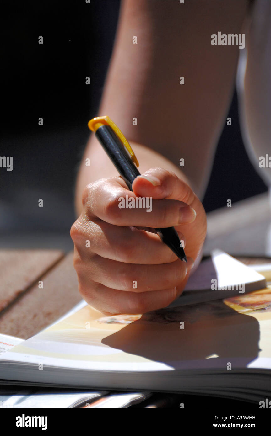 Woman's hand with pen, writing notes Stock Photo - Alamy