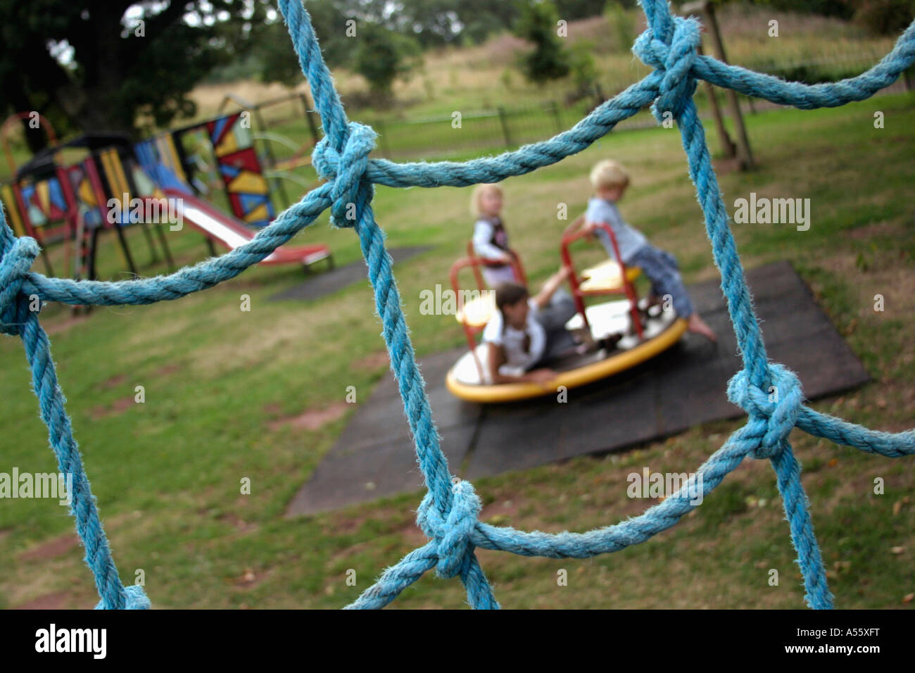 Children playing on a roundabout hi-res stock photography and images ...