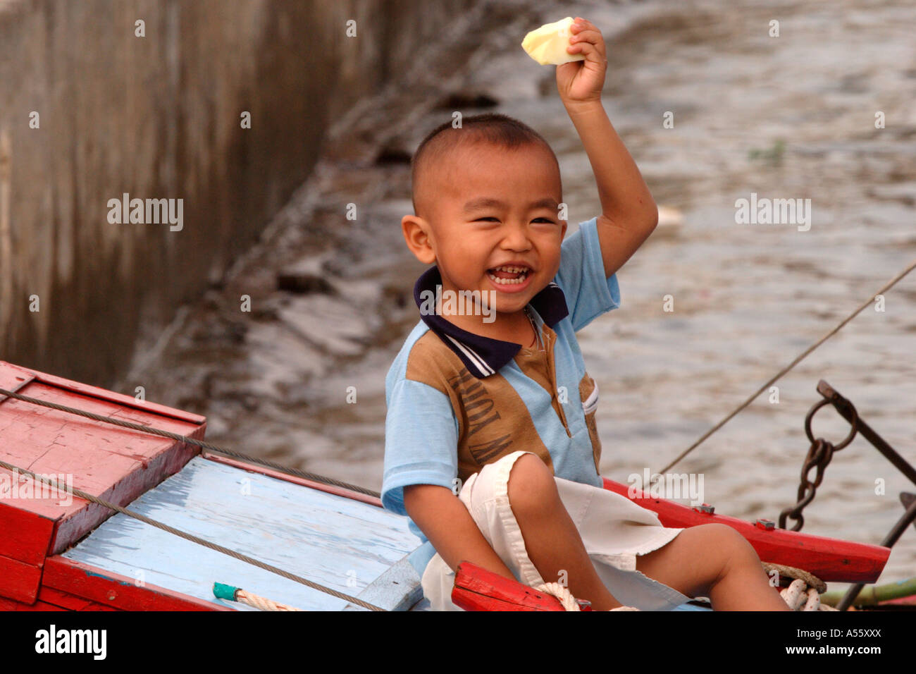 Happy Vietnamese child smiling and waving Stock Photo - Alamy