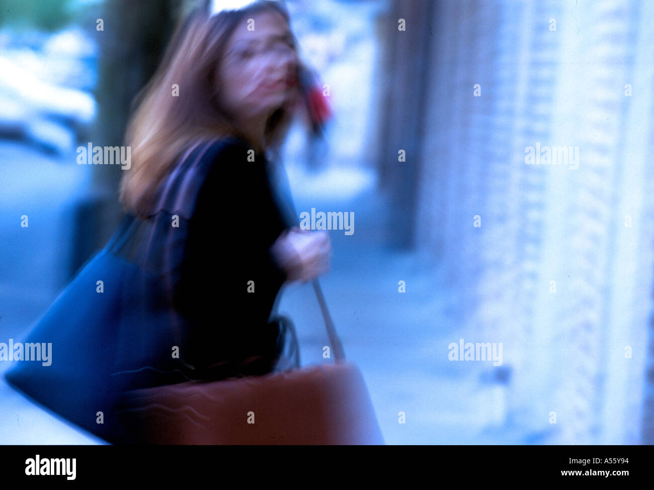 Woman walking looks behind her hi-res stock photography and images - Alamy